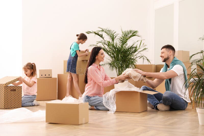 Happy Family Unpacking Moving Boxes in New House Stock Image - Image of ...