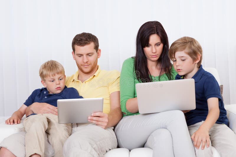 Jolly Family Using a Laptop on the Sofa Stock Image - Image of internet ...