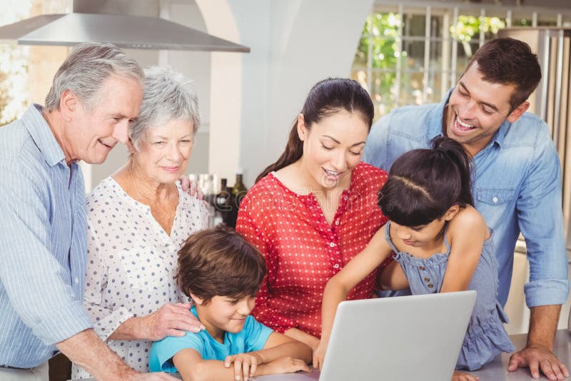 Happy family using laptop stock photo. Image of foreground - 68214216