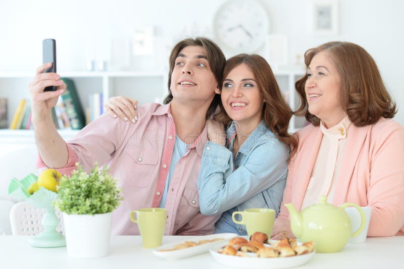 Happy Family Using Mobile Phone Together Stock Image - Image of friends ...