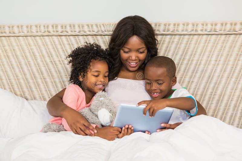 Happy Family Using Tablet in Bed Stock Photo - Image of female, abode ...