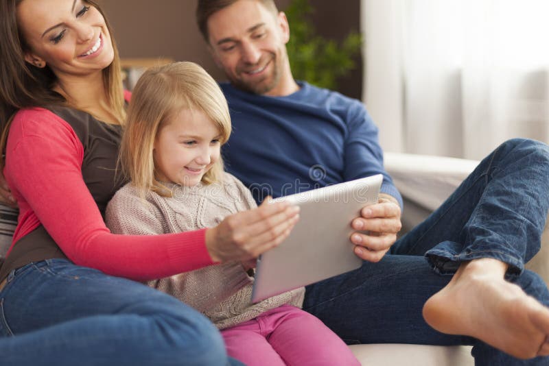 Happy family using tablet stock photo. Image of children - 39857458