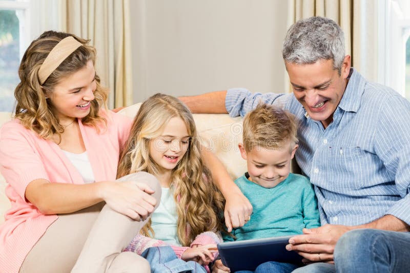 Happy Family Using Tablet on the Sofa Stock Photo - Image of child ...