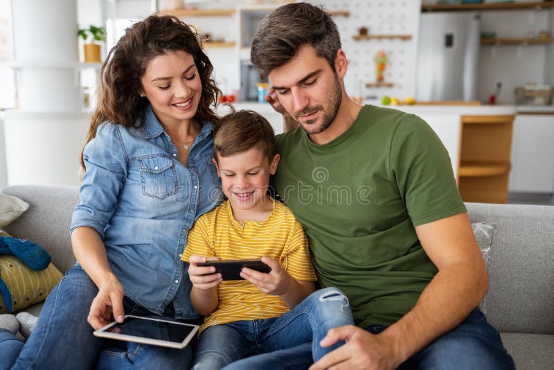 Happy Family Using Technology Devices Together at Home. Stock Image ...