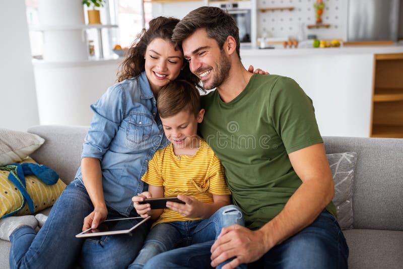 Happy Family Using Technology Devices Together at Home. Stock Photo ...