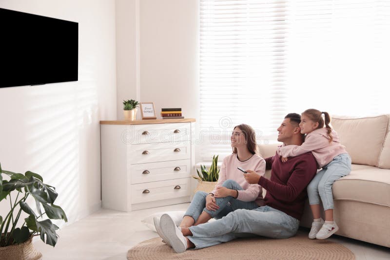 Happy Family Watching TV on Floor at Home Stock Photo - Image of girl ...