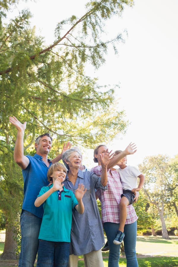 Happy Family Waving Hands in the Park Stock Photo - Image of laughing ...
