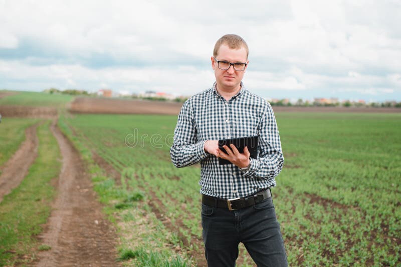 Happy Farmer in the Fields with a Laptop Computer Stock Photo - Image ...