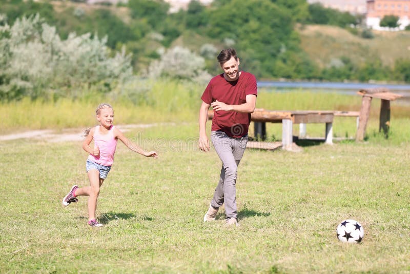 Happy Father and Daughter Playing Football Outdoors Stock Photo - Image ...