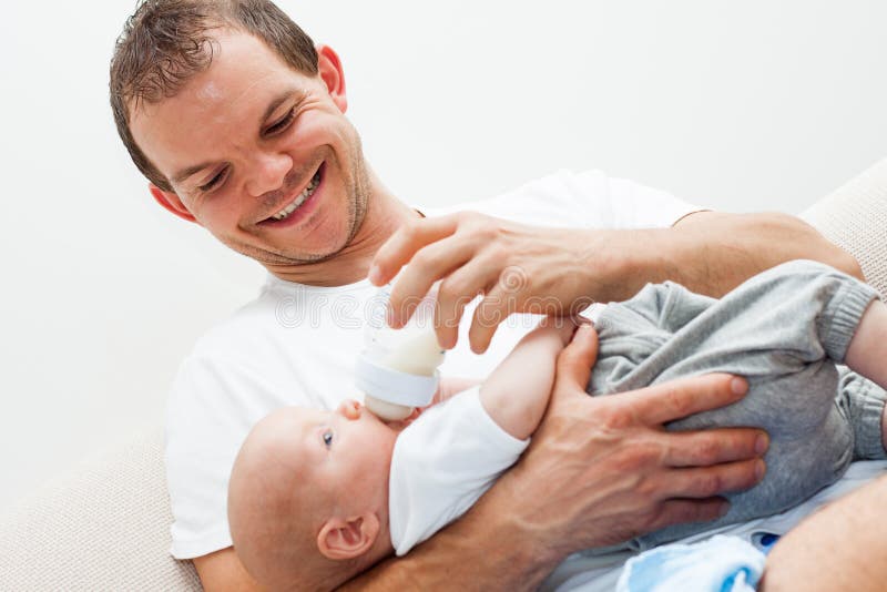 Happy Father Feeding His Son Stock Photo - Image of happiness, health ...