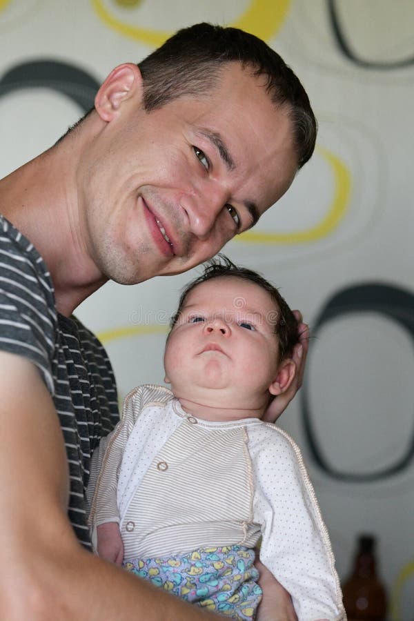 Happy Father Holding His Baby. Young Father Playing with His Daughter ... Happy Father Holding His Baby. Young Father Playing with His Daughter ...