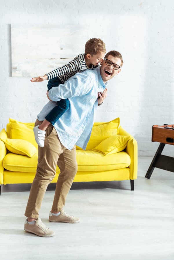 Happy Father Piggybacking Cheerful Son Imitating Stock Image - Image of ...