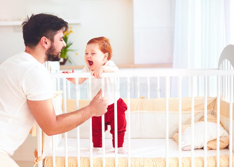 Happy Father Playing with Infant Baby in the Cot at Home Stock Image ...