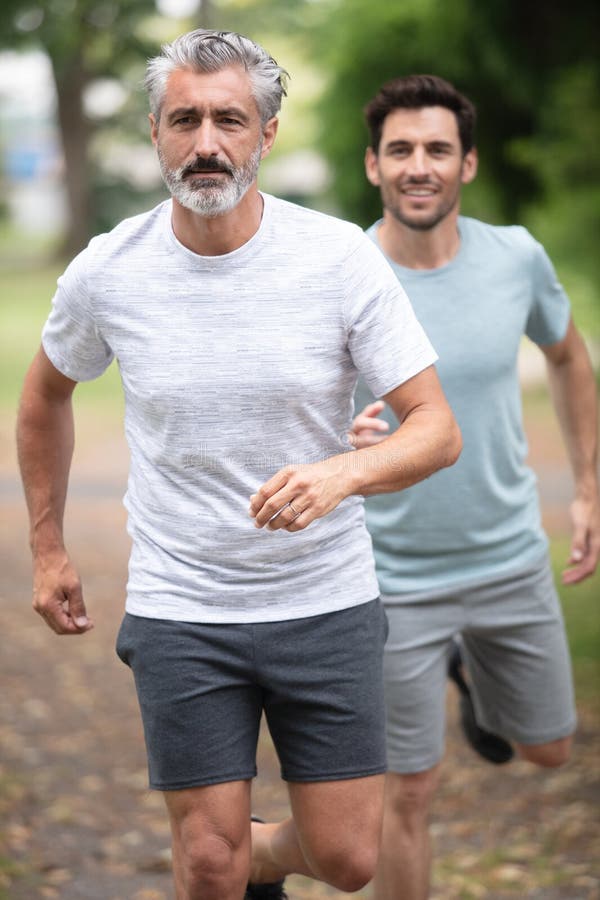 Happy Father and Son Jogging Together Outdoors in Park Stock Photo ...