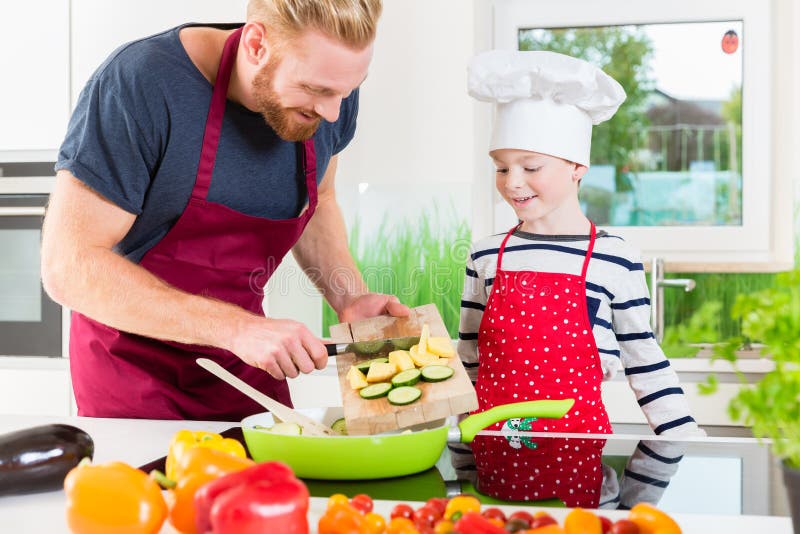 Father and Son Preparing Food Together in Kitchen Stock Image - Image ...
