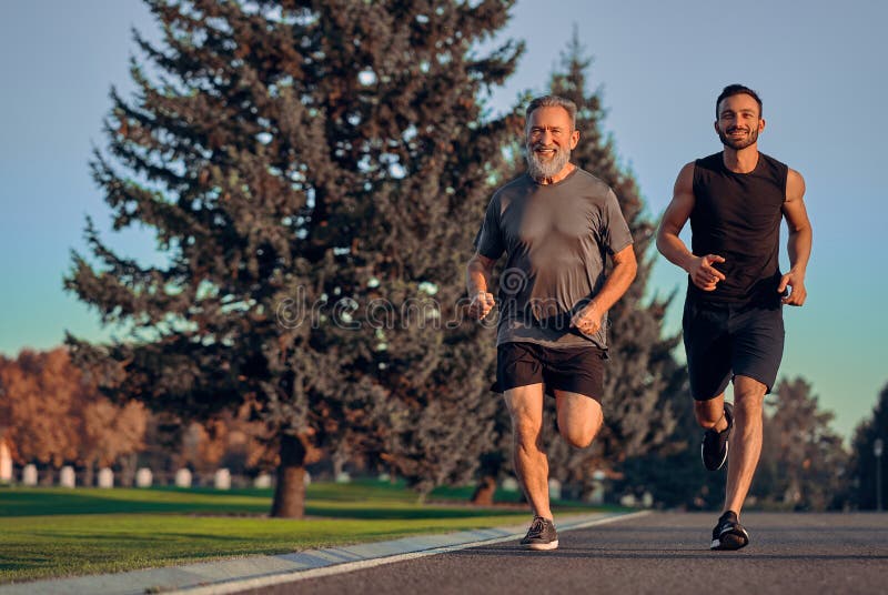The Happy Father and Son Running on the Road. Stock Image - Image of ...