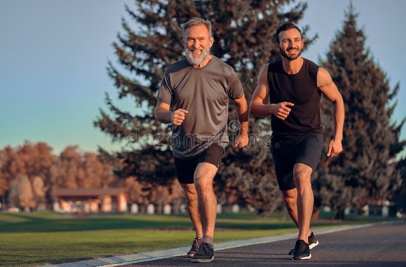 The Happy Father and Son Running on the Road. Stock Image - Image of ...