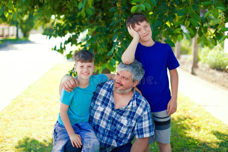 Happy Father with Two Young Sons Under Tree Stock Image - Image of ...