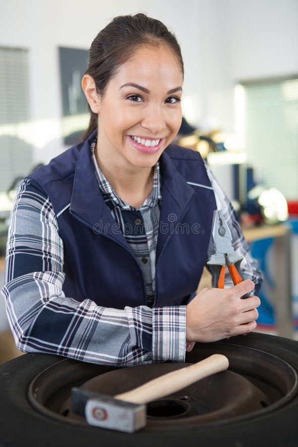 Happy Female Auto Mechanic Leaning on Tires Stock Photo - Image of ...