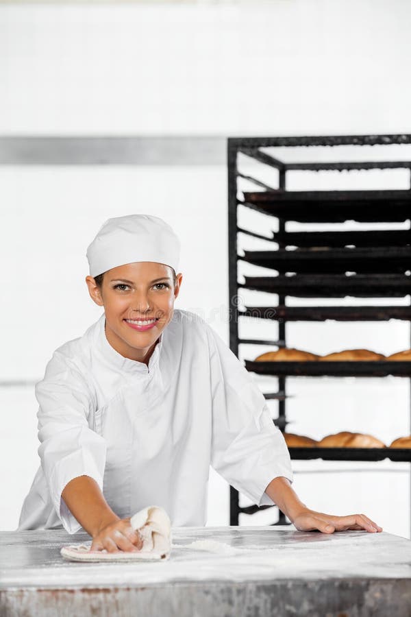 Happy Female Baker Cleaning Flour from Table Stock Photo - Image of ...
