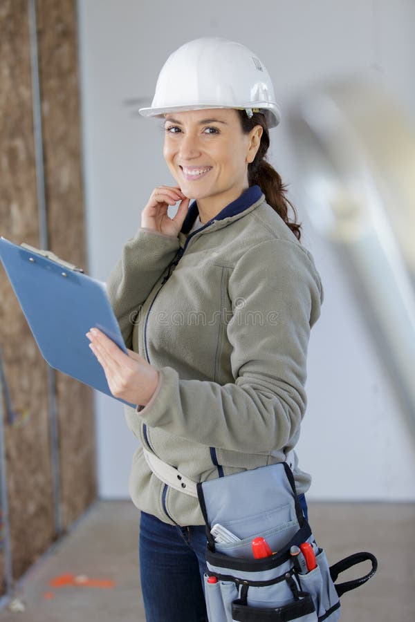 Happy Female Builder with Clipboard Stock Image - Image of smiling ...