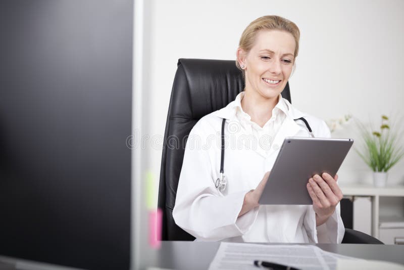 Happy Female Clinician Using Her Tablet Computer Stock Photo - Image of ...