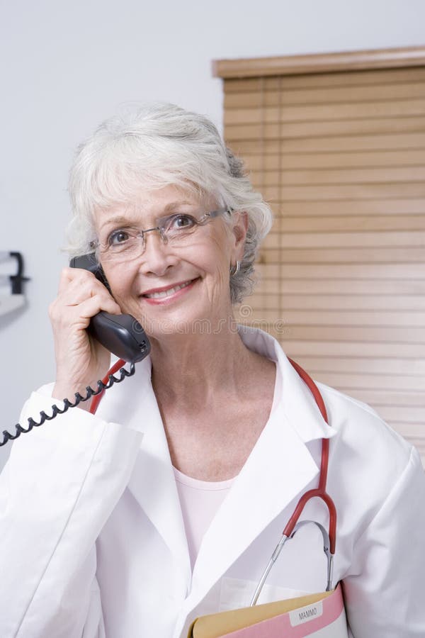 Senior Woman Using Cell Phone with Female Doctor Stock Photo - Image of ...