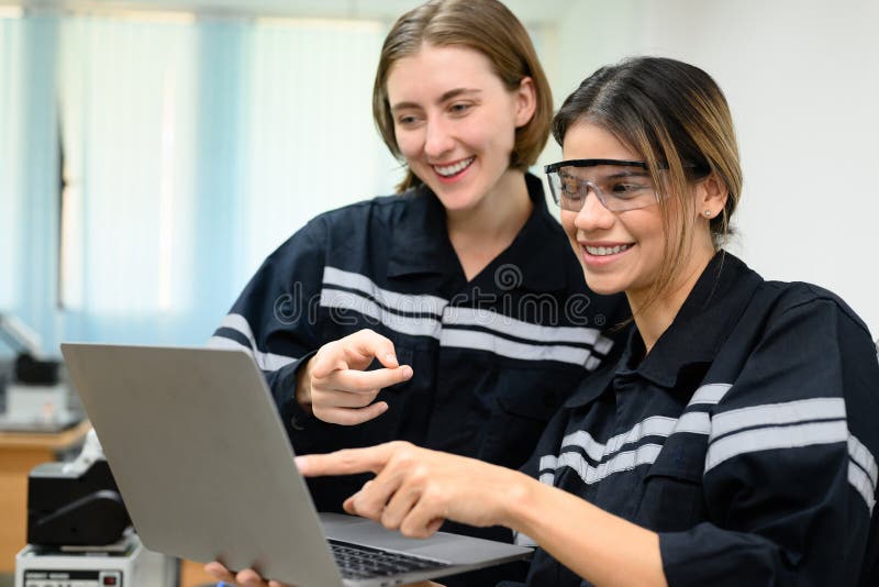 Happy Female Engineers Team Using Laptop Checking and Operating Stock ...