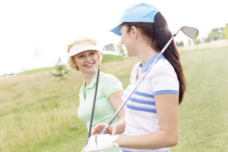 Happy Female Golfers Talking at Golf Course Stock Image - Image of ...