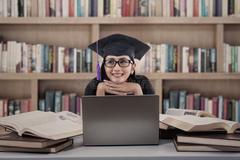 Happy Female Graduate Thinking at Library Stock Photo - Image of happy ...