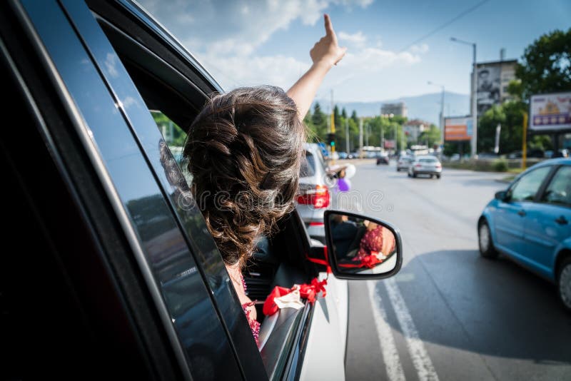 Happy Female Looking Out of a Window of a Car and Greeting Stock Photo ...
