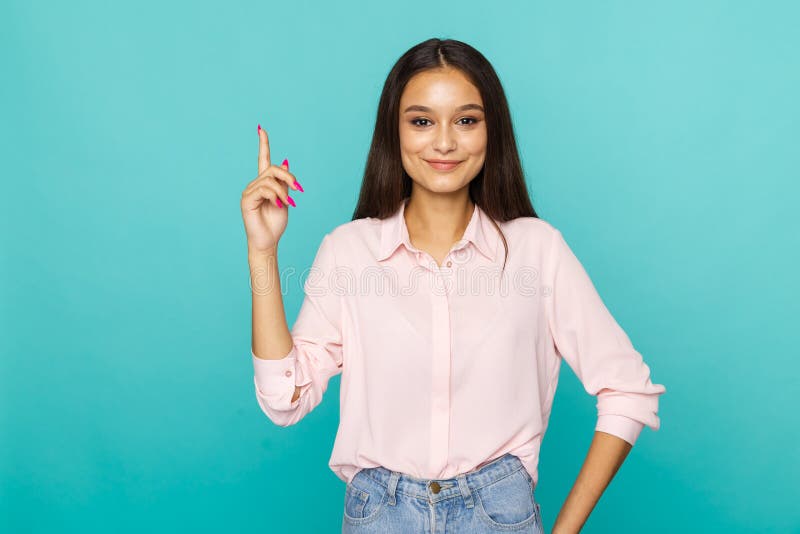 Happy Female Model in the White Blouse is on the Blue Studio Pointing ...