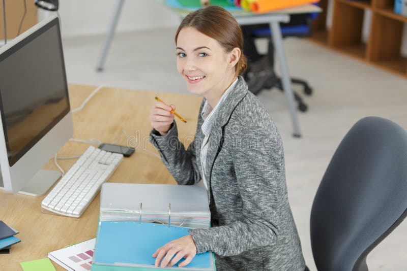 Happy female office worker stock photo. Image of book - 118888854