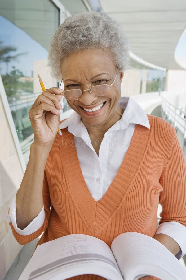 Happy Female Professor with Book Stock Image - Image of outdoors ...