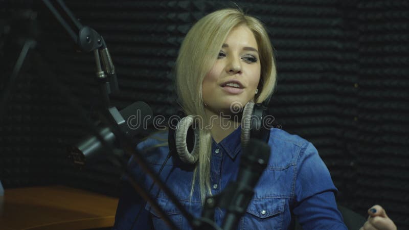 Happy Female Radio Host Broadcasting through Microphone in Studio Stock ...