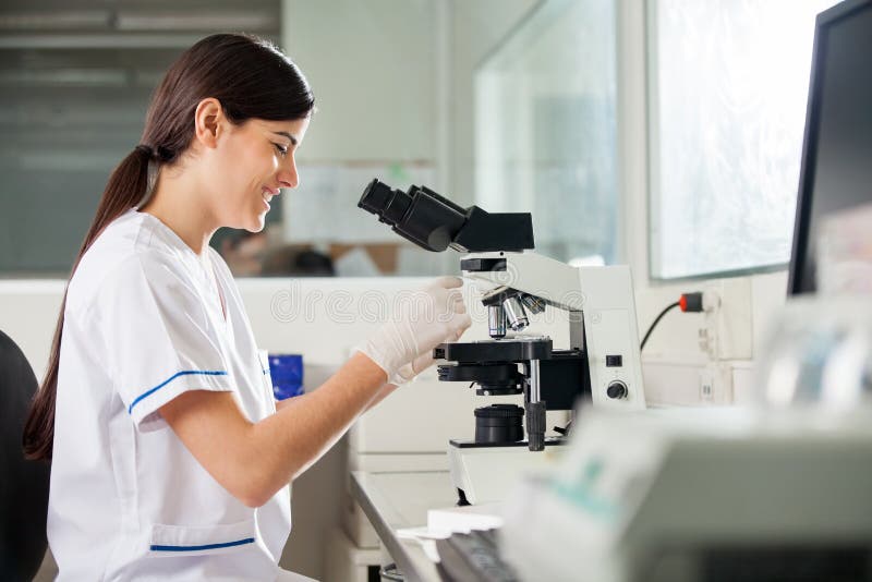Happy Female Scientist Using Microscope in Lab Stock Image - Image of ...