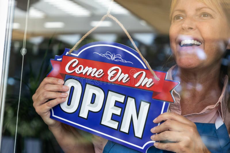Happy Female Store Owner Turning Open Sign in Window Stock Photo ...