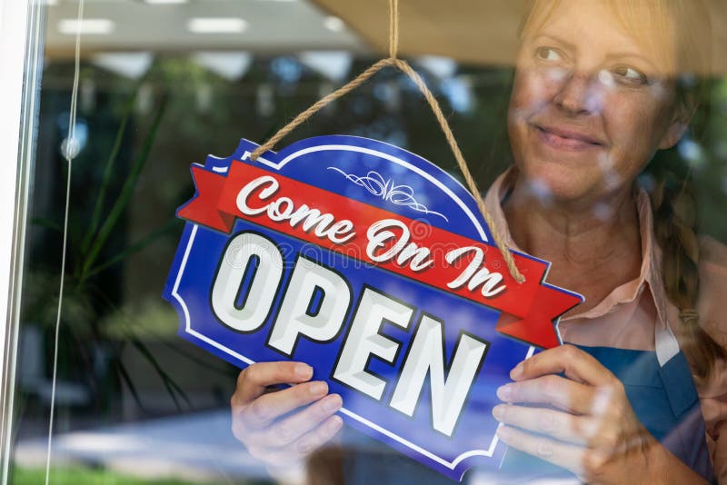Happy Female Store Owner Turning Open Sign in Window Stock Photo ...