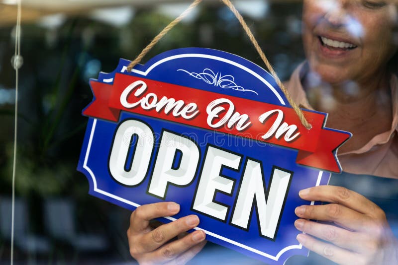 Happy Female Store Owner Turning Open Sign in Window Stock Photo ...