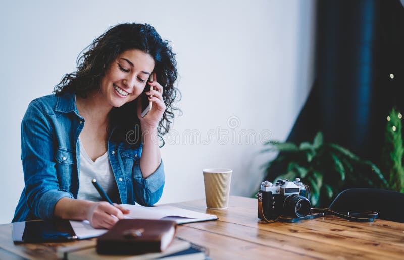 Happy Female Student Writing Information in Education Textbook Using ...