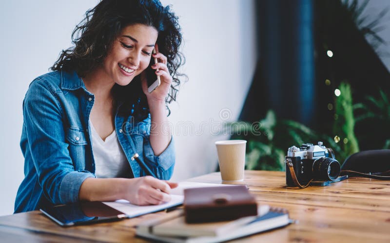 Happy Female Student Writing Information in Education Textbook Using ...