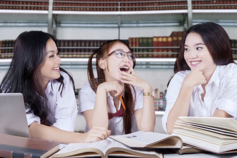 Happy Female Students Talking in Library Stock Image - Image of female ...