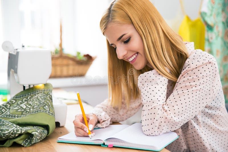 Happy Female Tailor Writing Notes Stock Photo - Image of creative ...