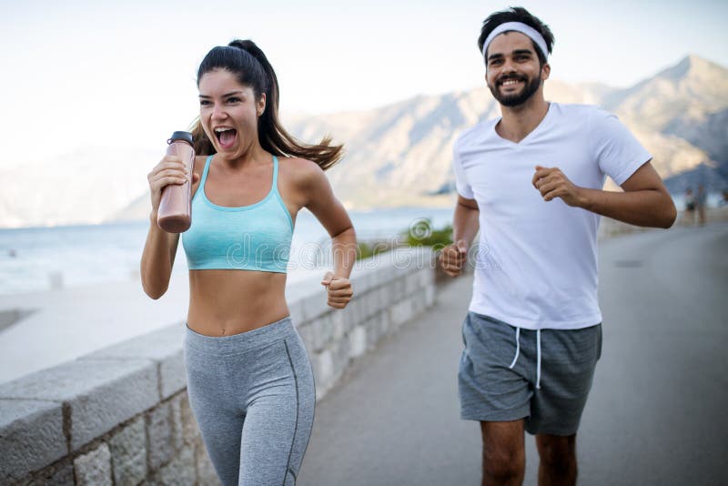 Happy Fit People Couple Jogging and Running Outdoors Stock Photo ...