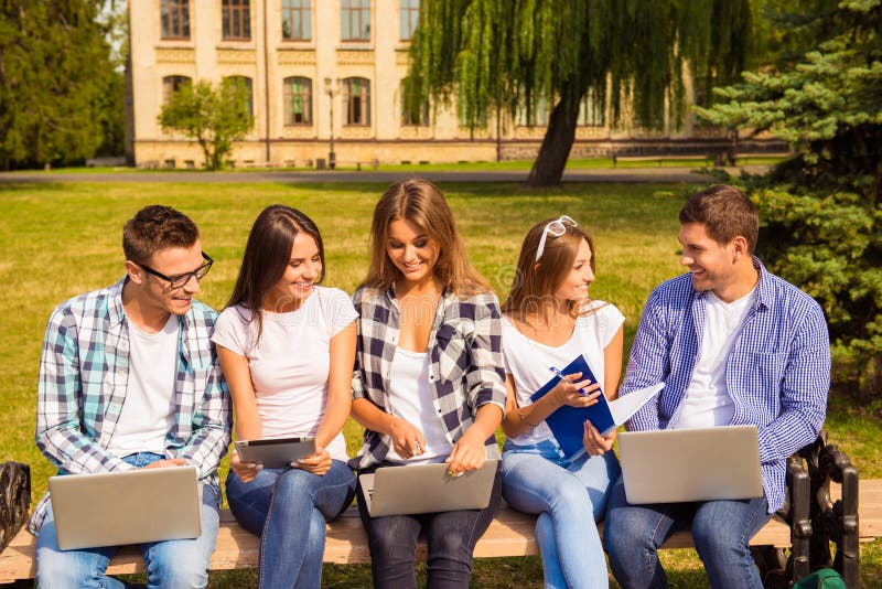 Happy Five Diverse Classmates Sitting on Bench and Study Up Stock Photo ...