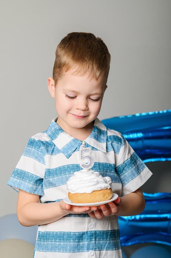 Happy Five Year Old Boy Celebrating Birthday with Cupcake and Candle ...