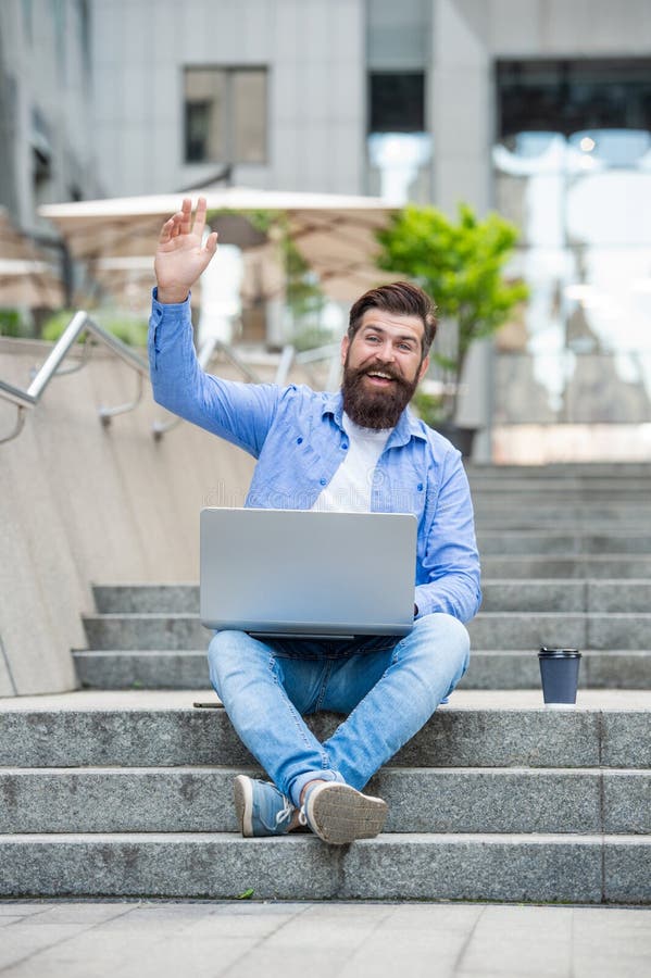 Happy Freelancer Making Hi Gesture Sitting on Stairs. Freelancer Guy ...