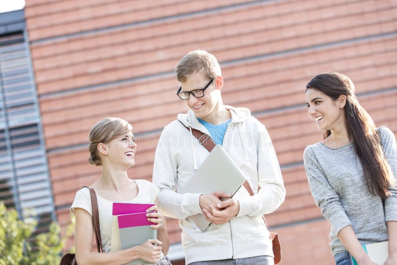 Happy Friends with Books Talking in University Campus Stock Image ...