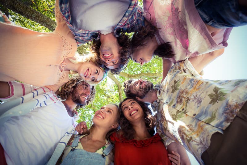 Happy Friends Forming a Huddle in Park Stock Photo - Image of cheerful ...