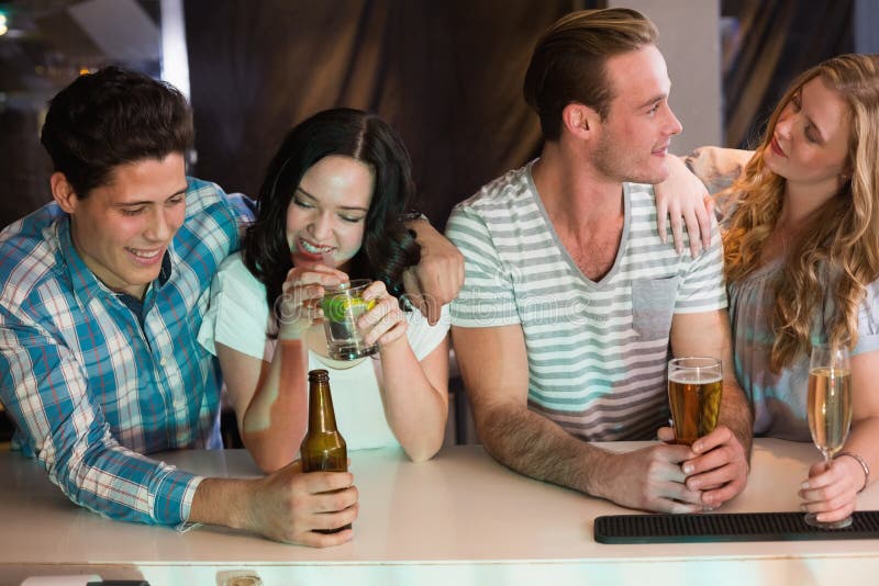 Happy Friends Having a Drink Together Stock Photo - Image of looking ...